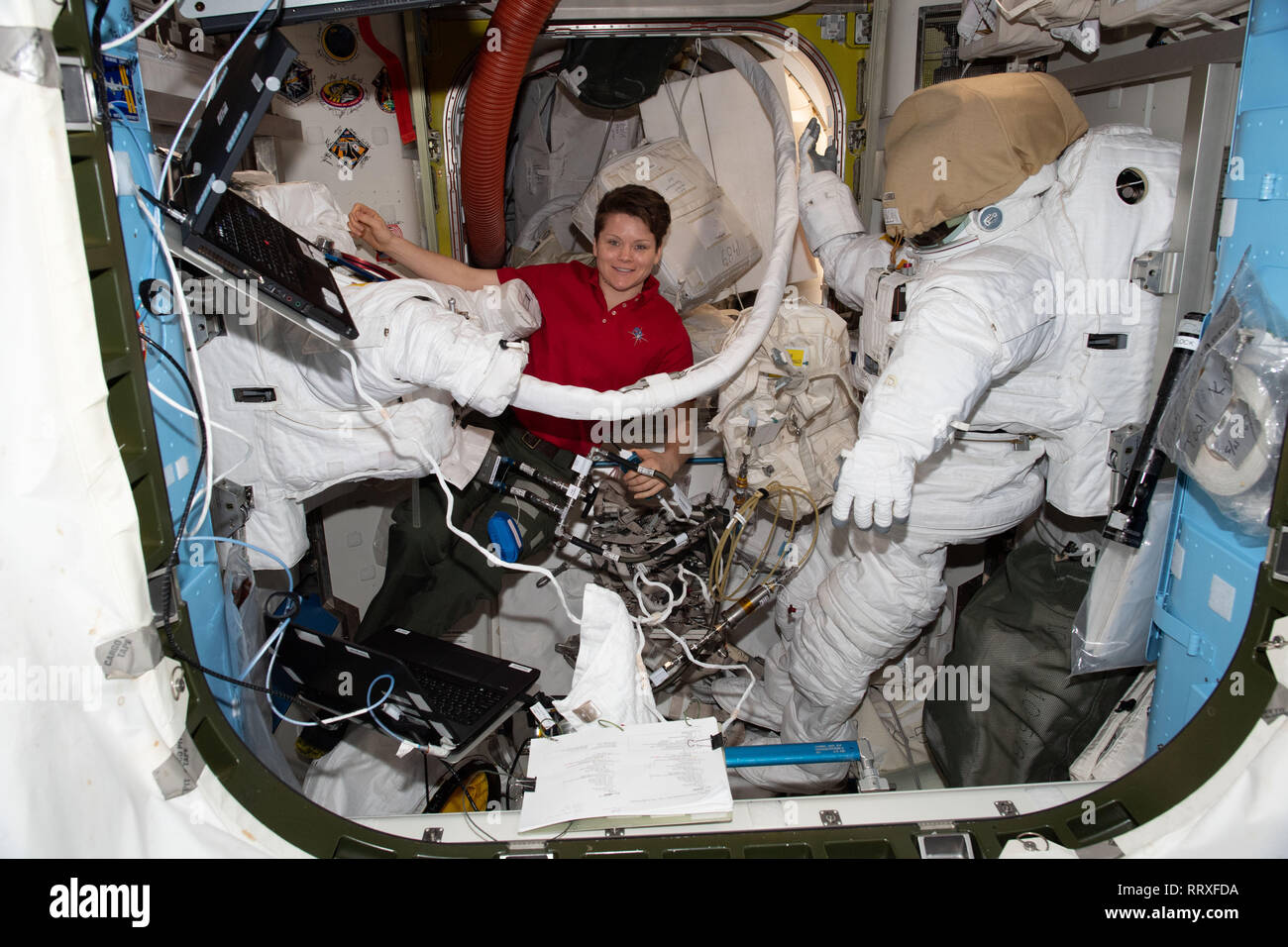 NASA astronaut Anne McClain works inside the Quest joint airlock ...