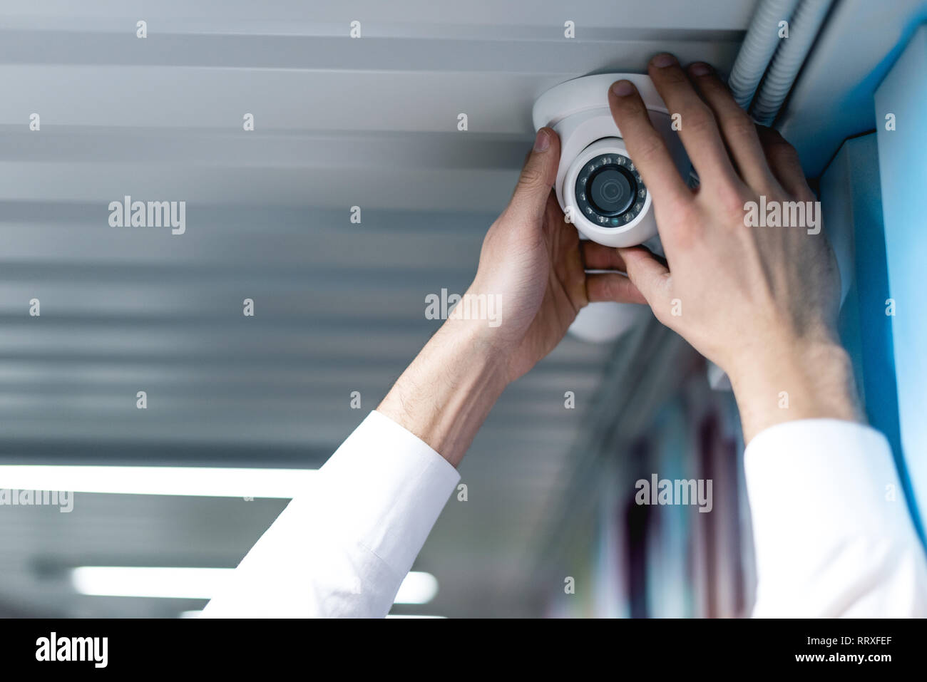 partial view of man setting up security camera Stock Photo - Alamy