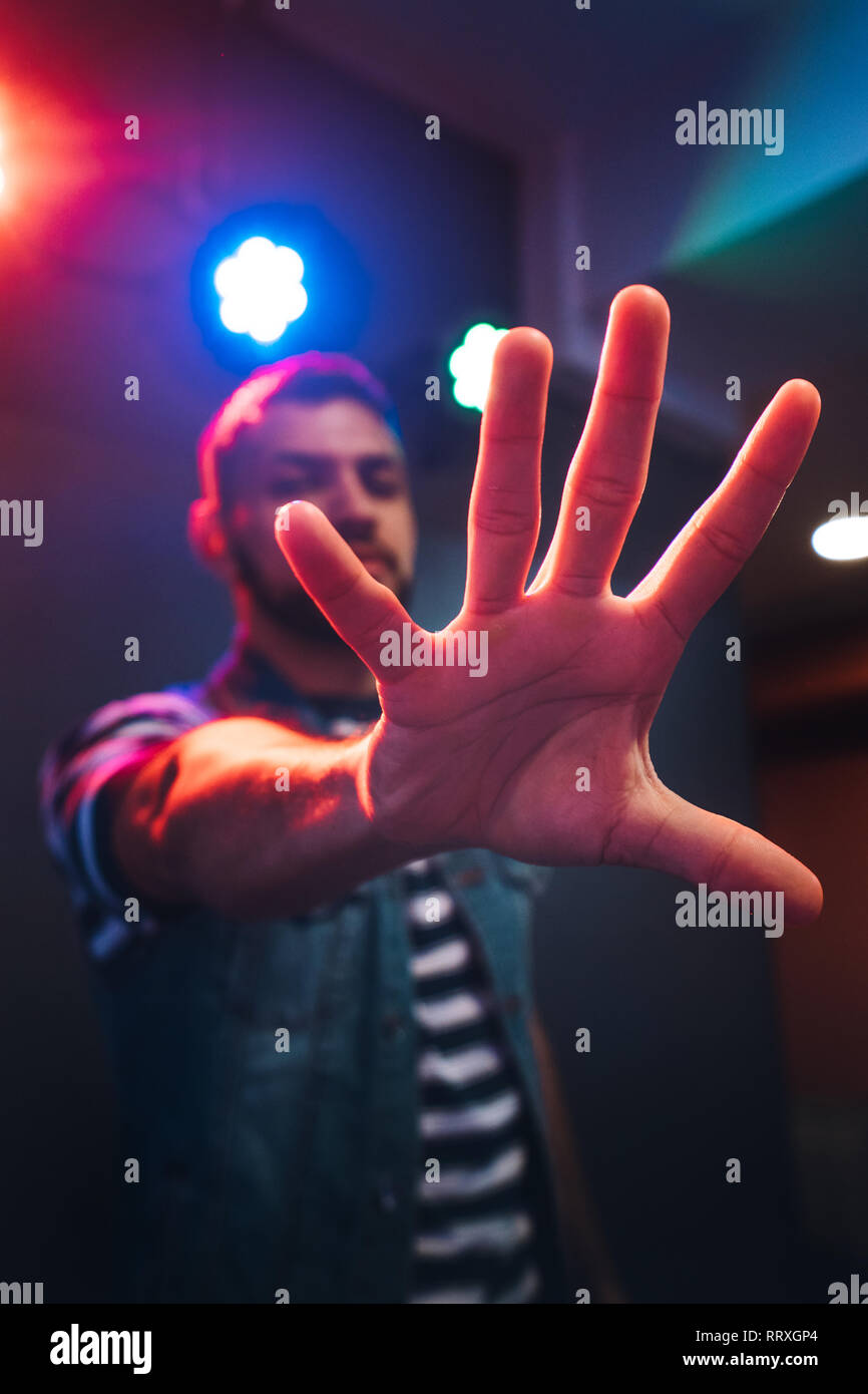 man dancing in spotlight outstretching hand forward Stock Photo - Alamy