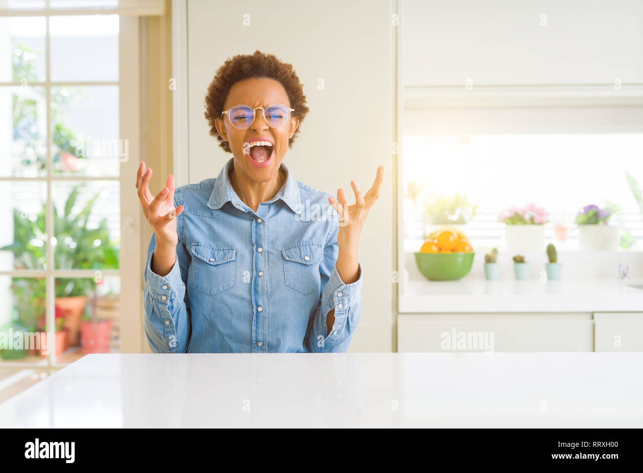 Young beautiful african american woman wearing glasses celebrating mad ...