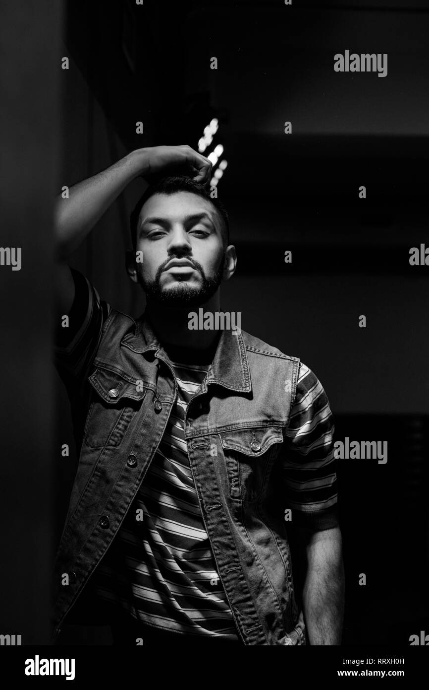 Handsome bearded man dancing in spotlight Stock Photo - Alamy