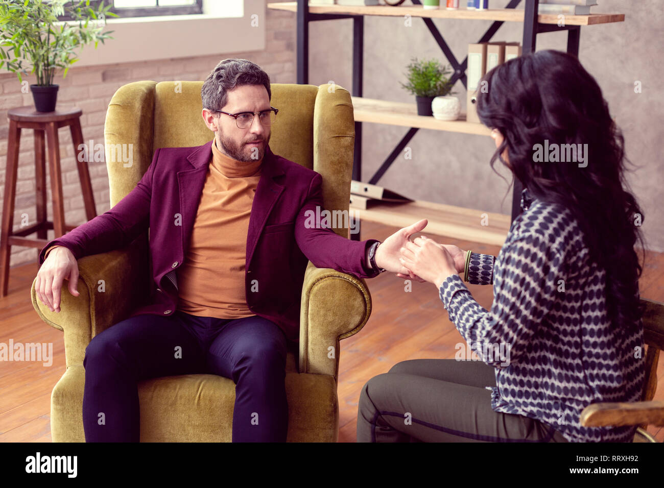 Nice handsome serious businessman giving his hand Stock Photo - Alamy
