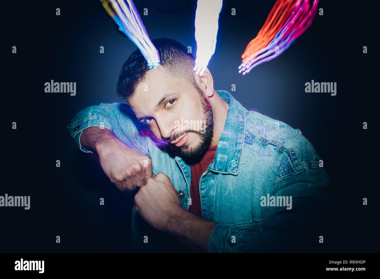 Handsome bearded man dancing in spotlight Stock Photo - Alamy