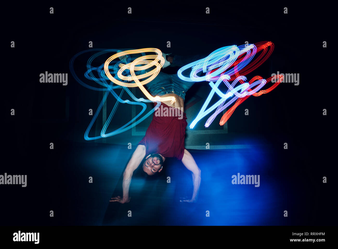 Handsome bearded man dancing in spotlight Stock Photo - Alamy