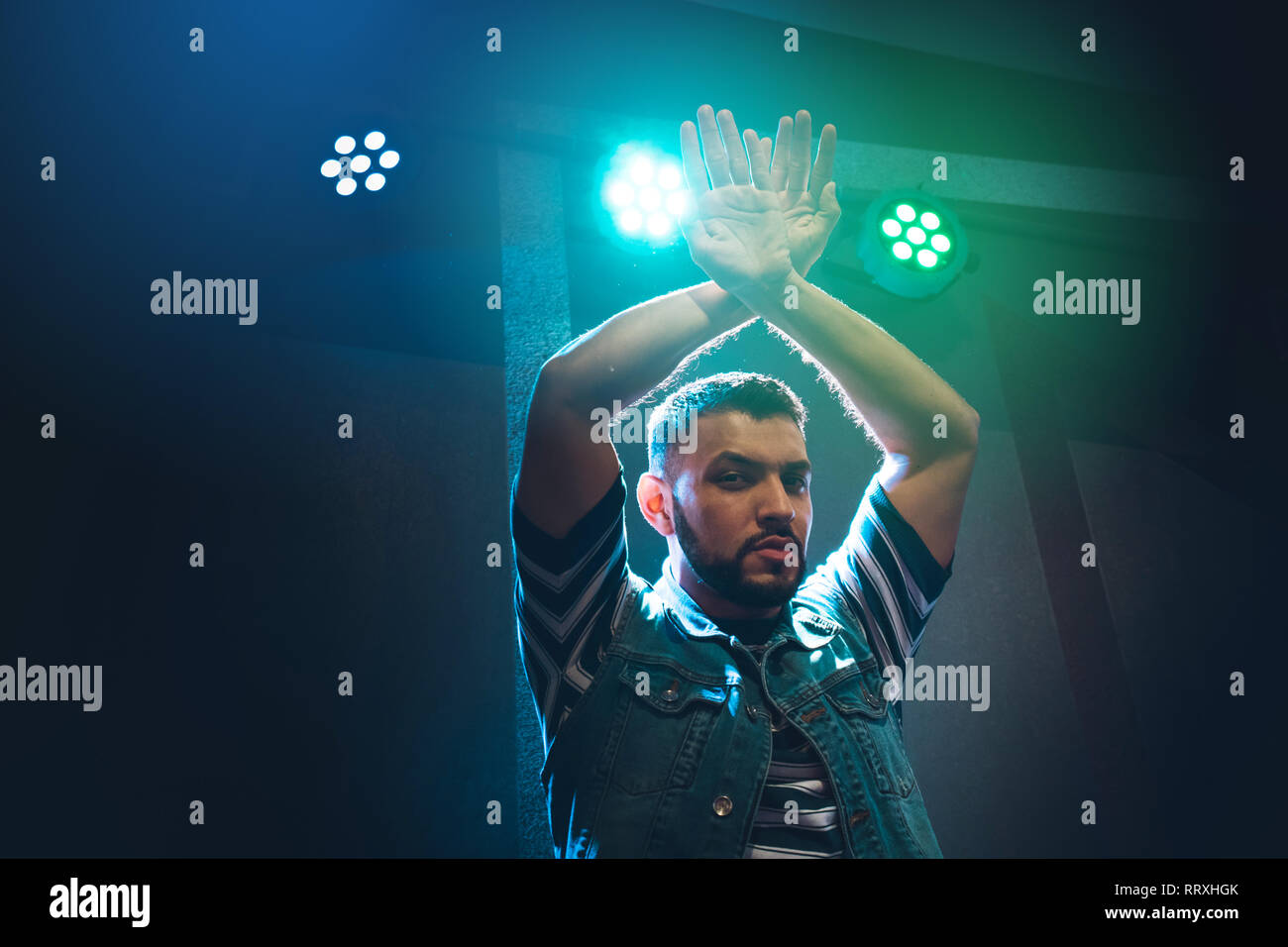 Handsome bearded man dancing in spotlight Stock Photo - Alamy