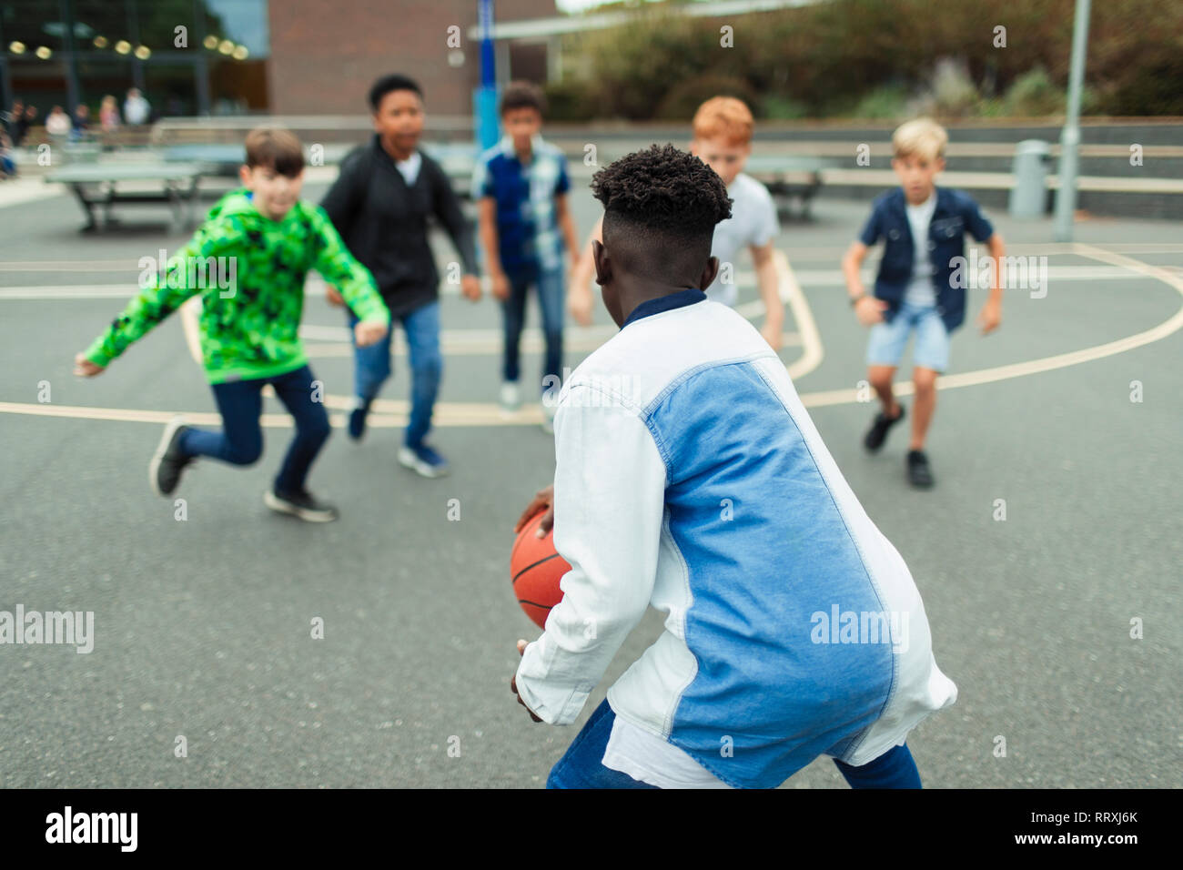 Tween boys playing basketball in schoolyard Stock Photo - Alamy