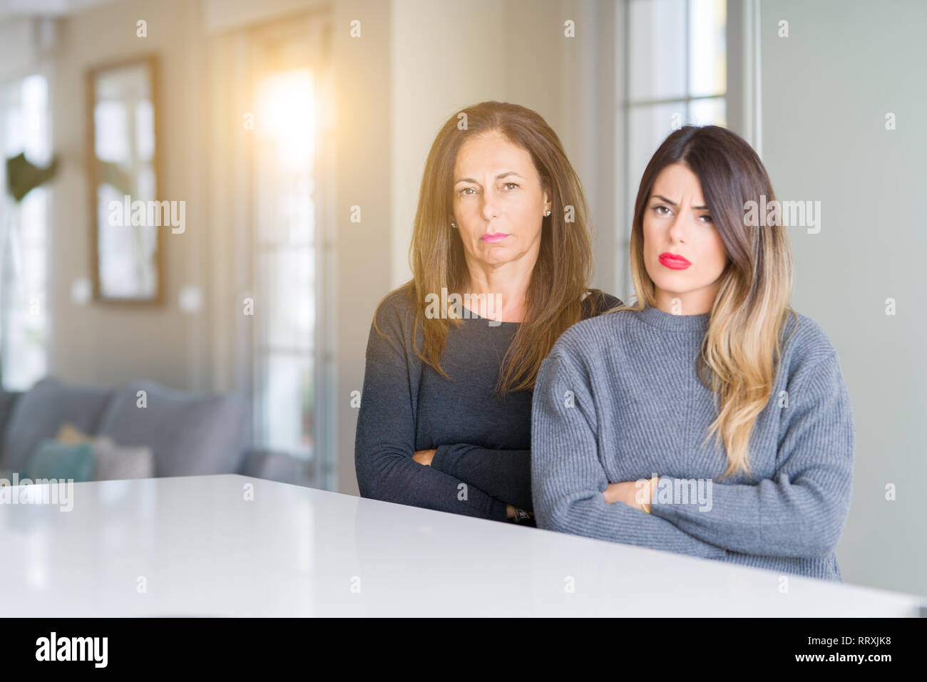 Beautiful family of mother and daughter together at home skeptic and ...