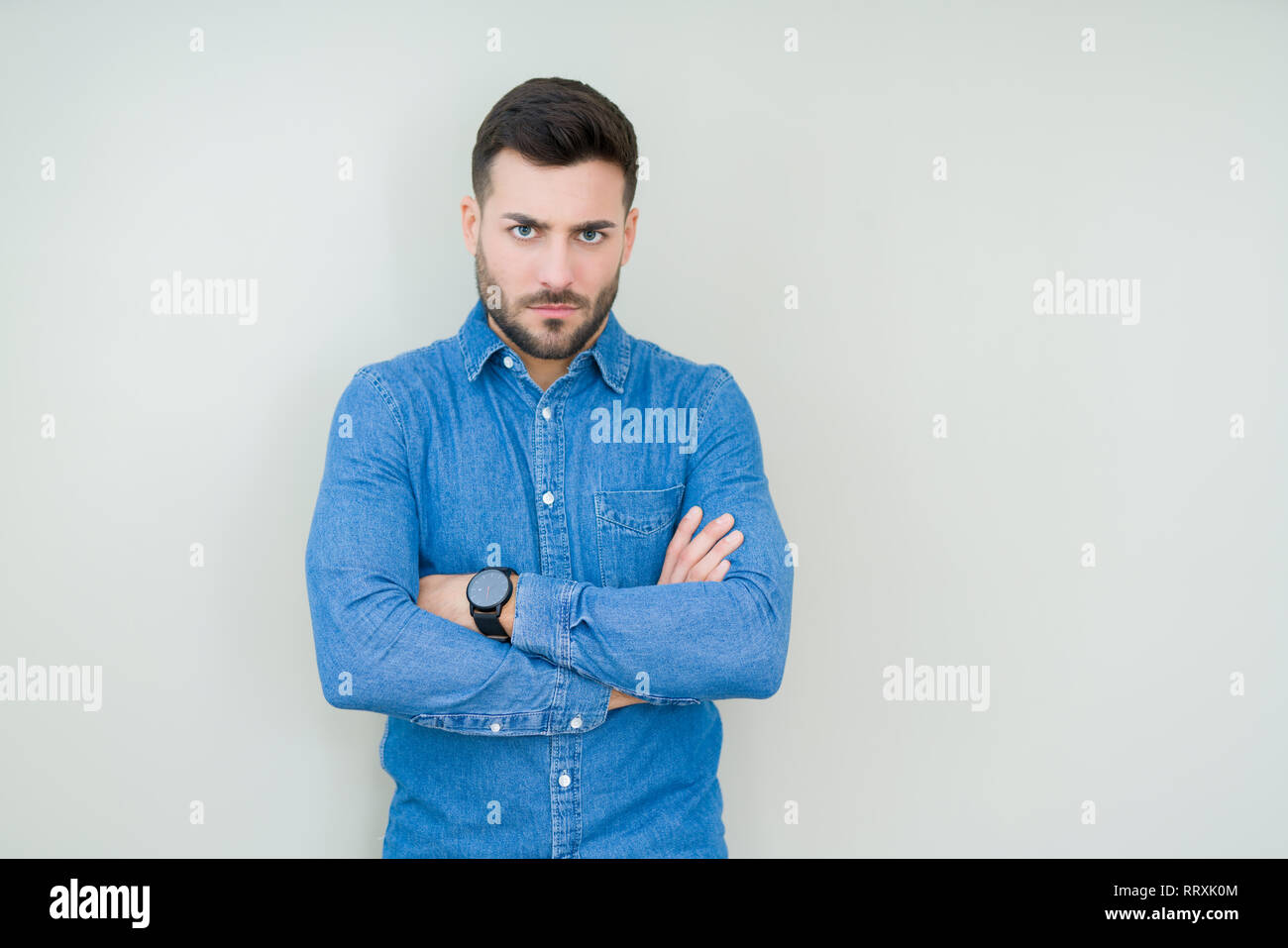 Young handsome man over isolated background skeptic and nervous ...