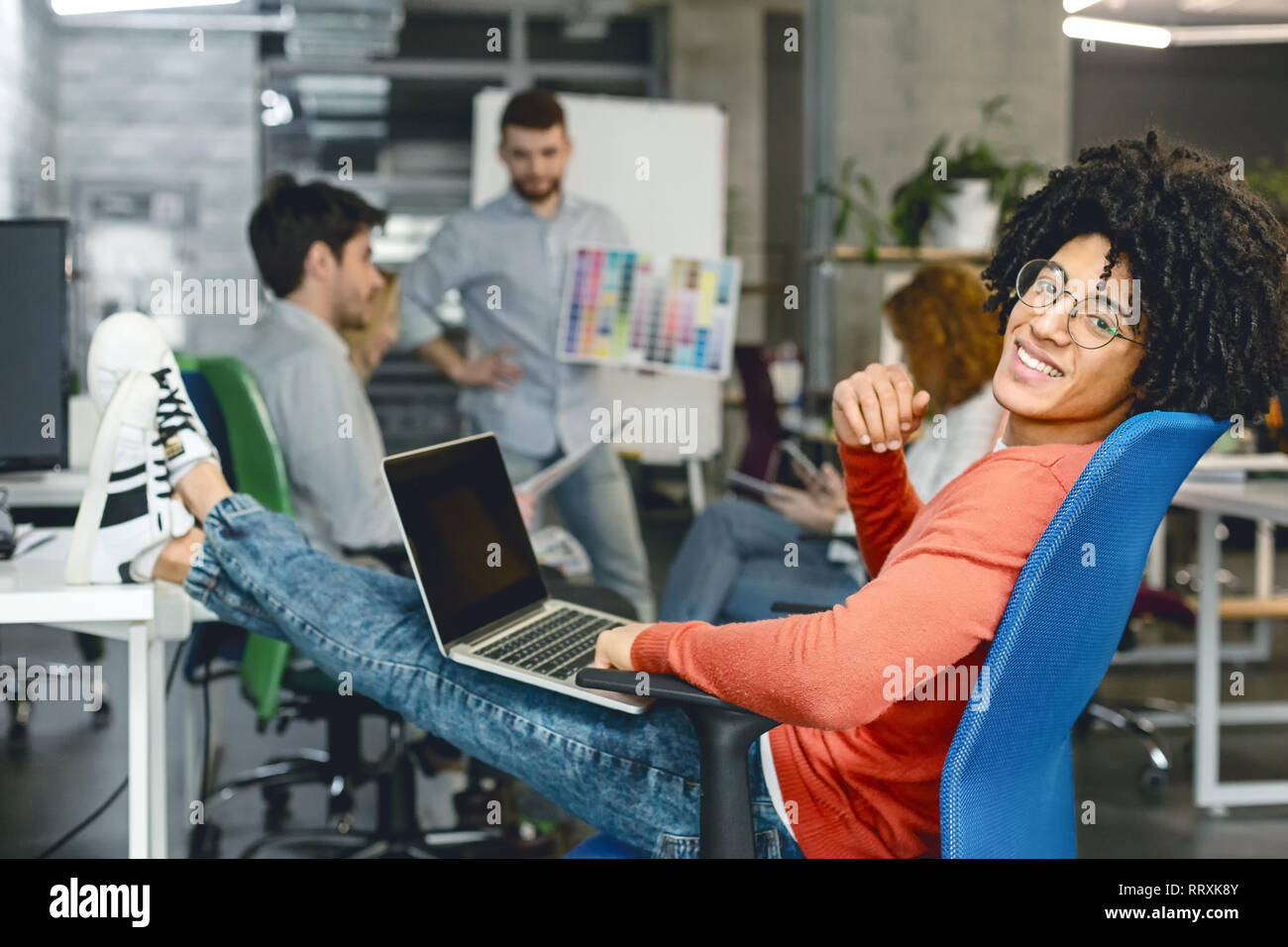 Happy calm smiling man having rest after solving all the tasks at work ...