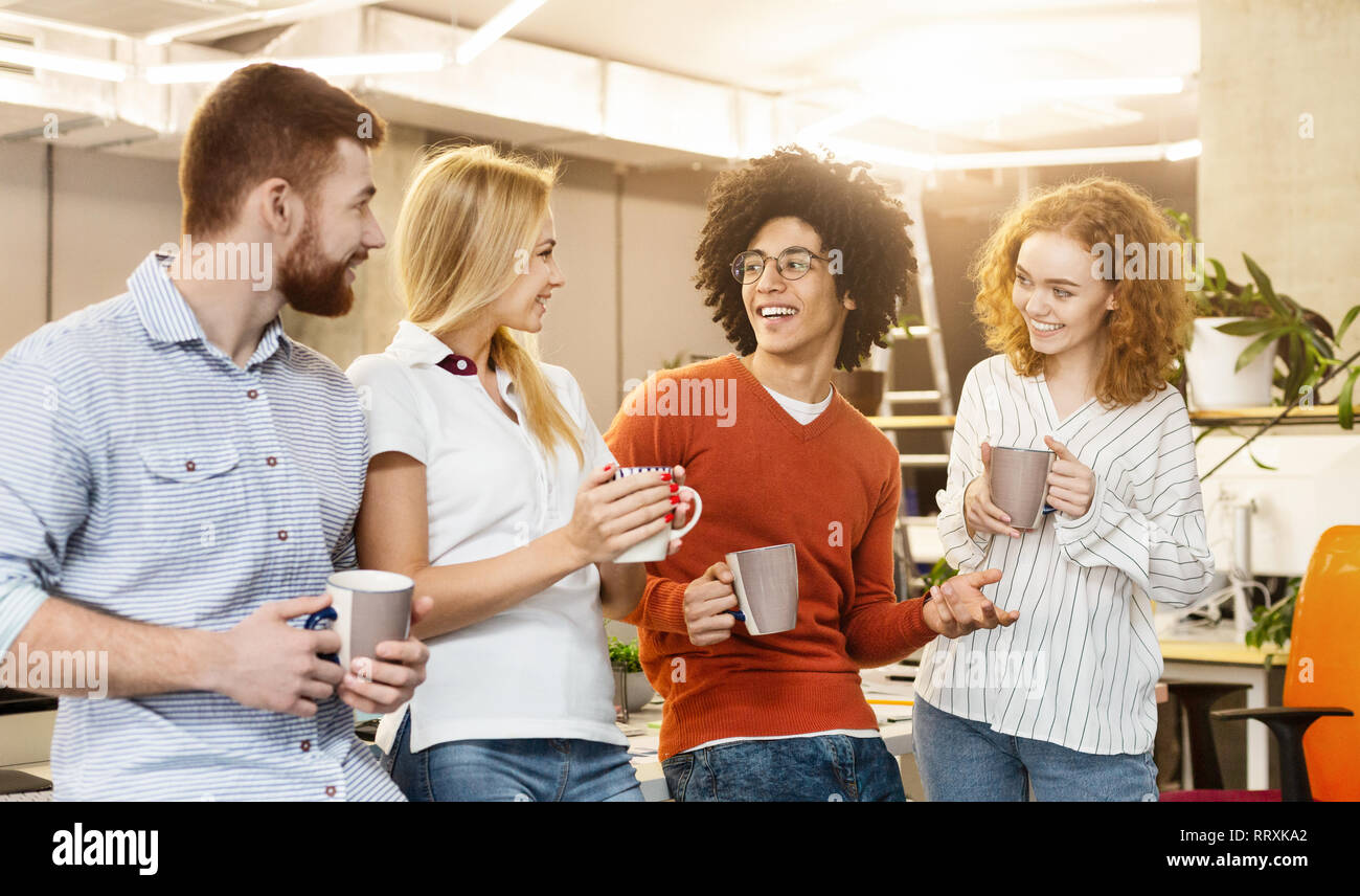 Cheerful colleagues enjoying coffee break in office Stock Photo - Alamy