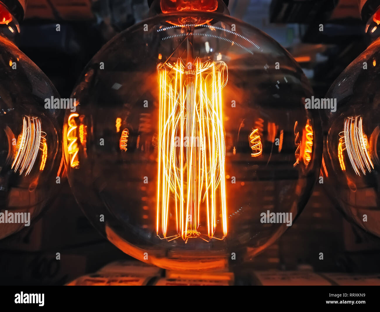 Bright glowing clear glass lamp spherical shape close up. Illumination ...