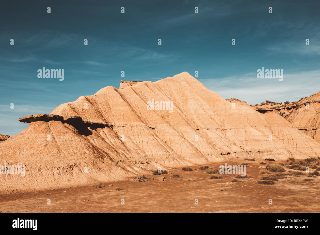 Desert cliffs under blue sky in landscape Stock Photo - Alamy