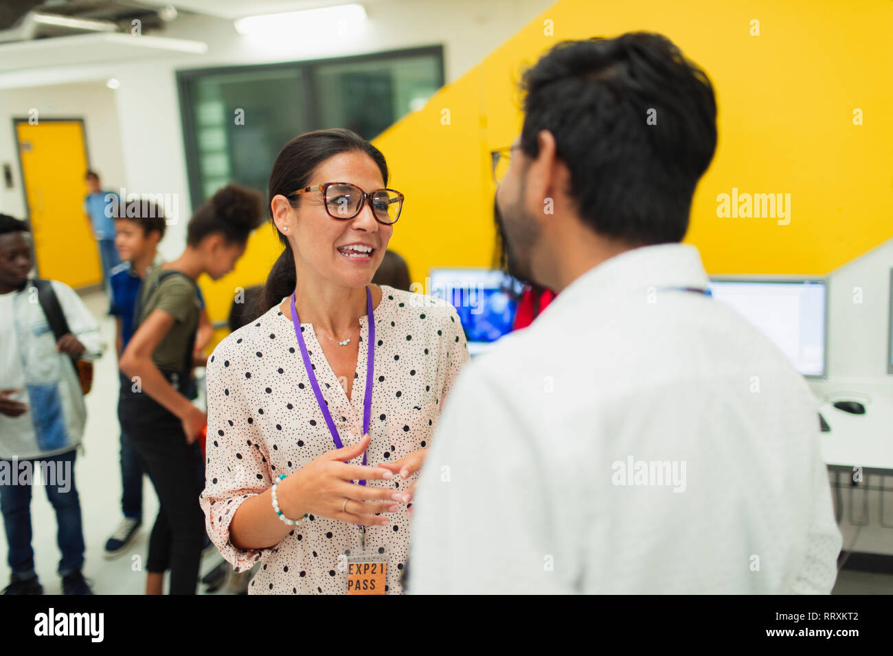 Teachers talking library Stock Photo - Alamy