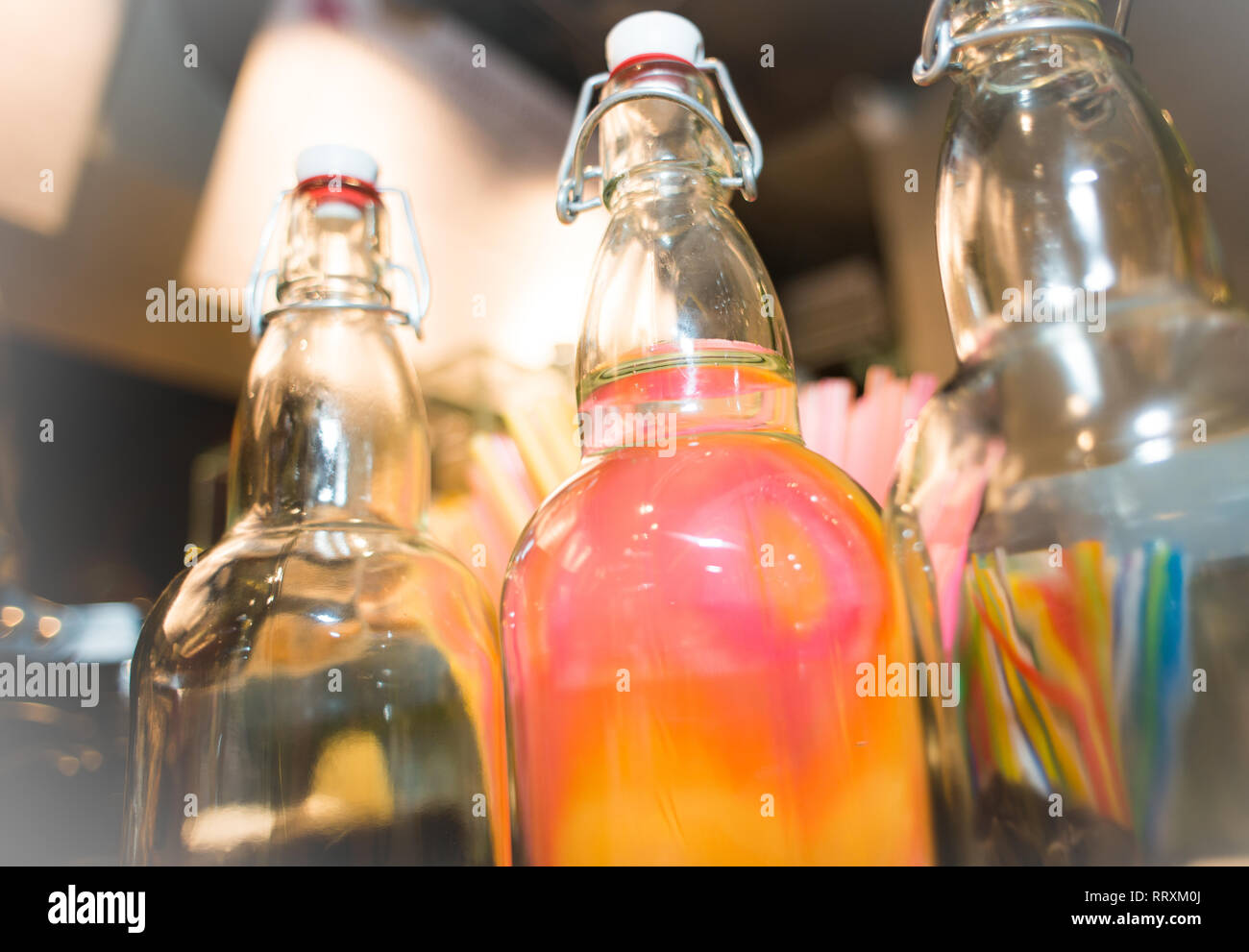 Bottles with colourful drinks at the bar stand Stock Photo - Alamy