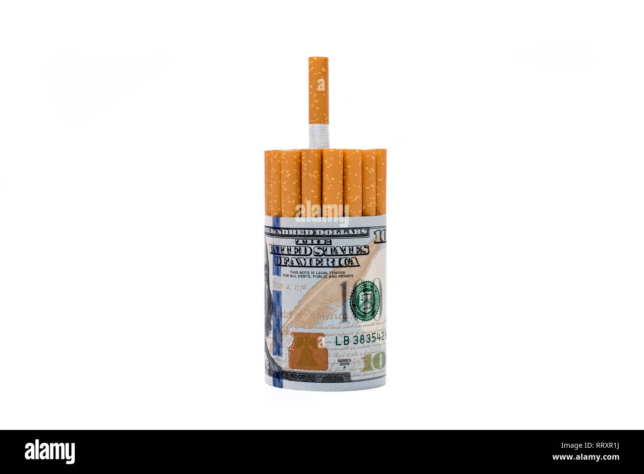 Smoking and money cost. Cigarettes wrapped in hundred dollars banknotes ...