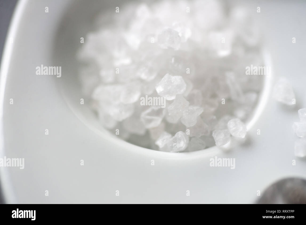 large white sea salt scattered on a saucer Stock Photo - Alamy