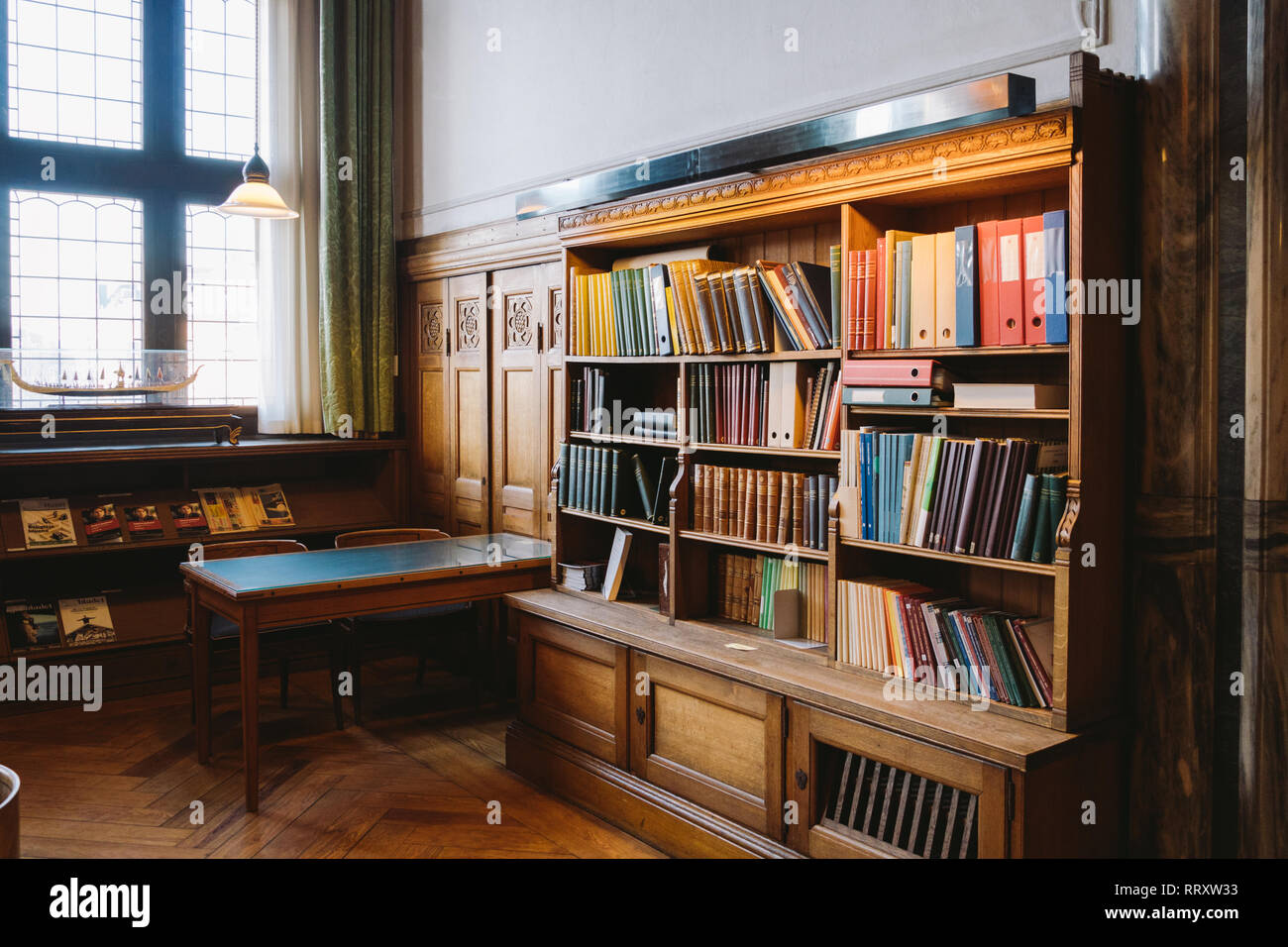 Storage of books. Large old library in the Gothic style. Shelves and ...