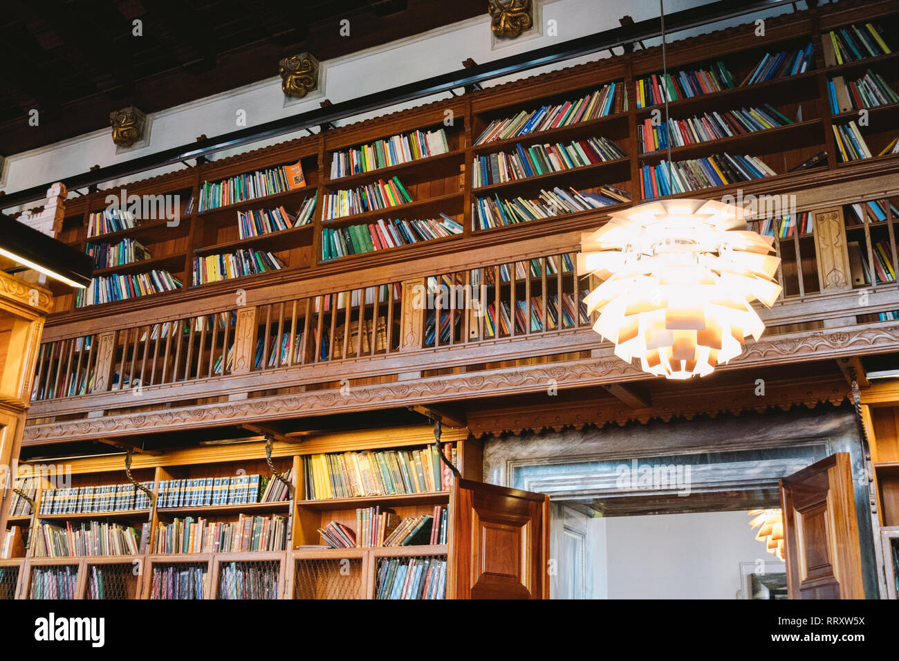 Storage of books. Large old library in the Gothic style. Shelves and ...