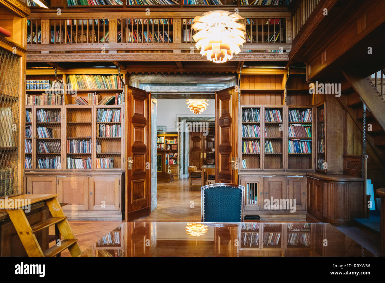 Storage of books. Large old library in the Gothic style. Shelves and rows with books. City ...