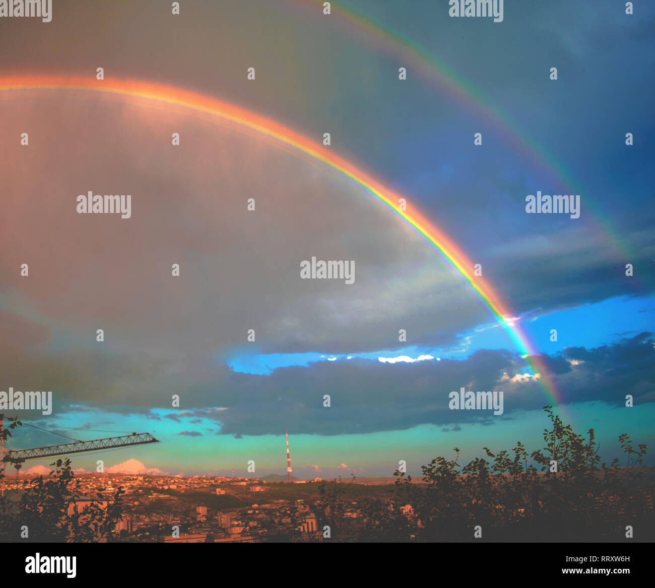 Rainbow and Spring green grass and sun on blue sky background Stock ...