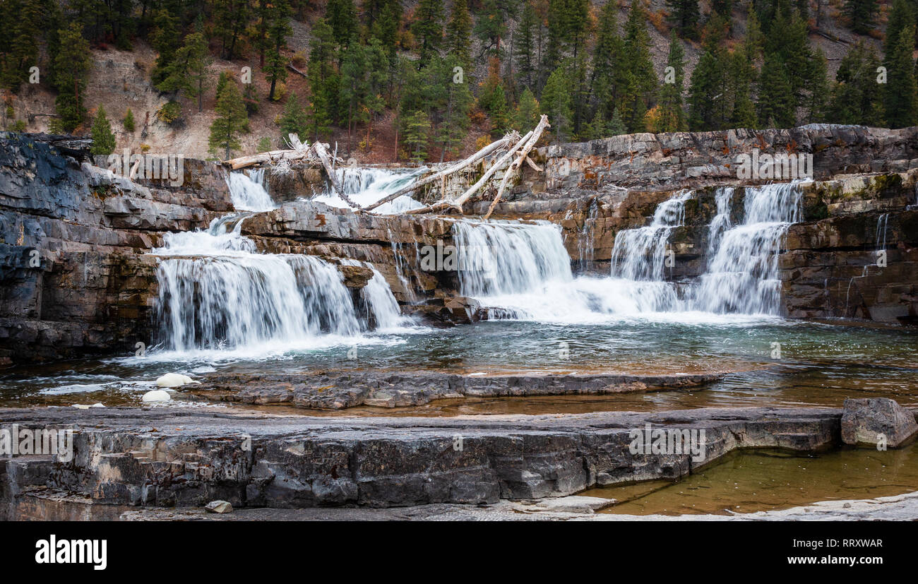 A series of waterfalls over a natural rock wall Stock Photo - Alamy