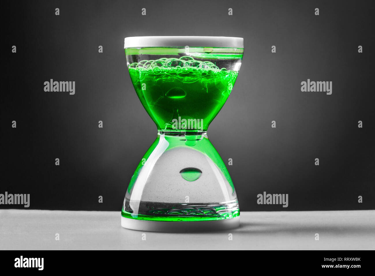 liquid hourglass made of water and oil, on gray background Stock Photo ...