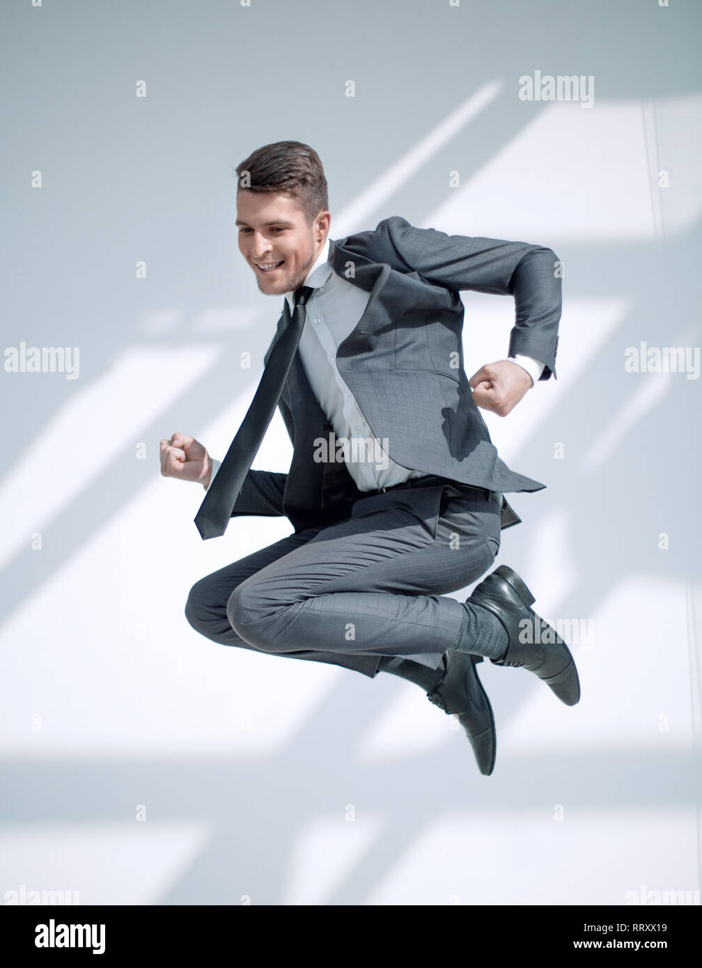 Full-length jump of a young man jumping with an open mouth, isolated on ...