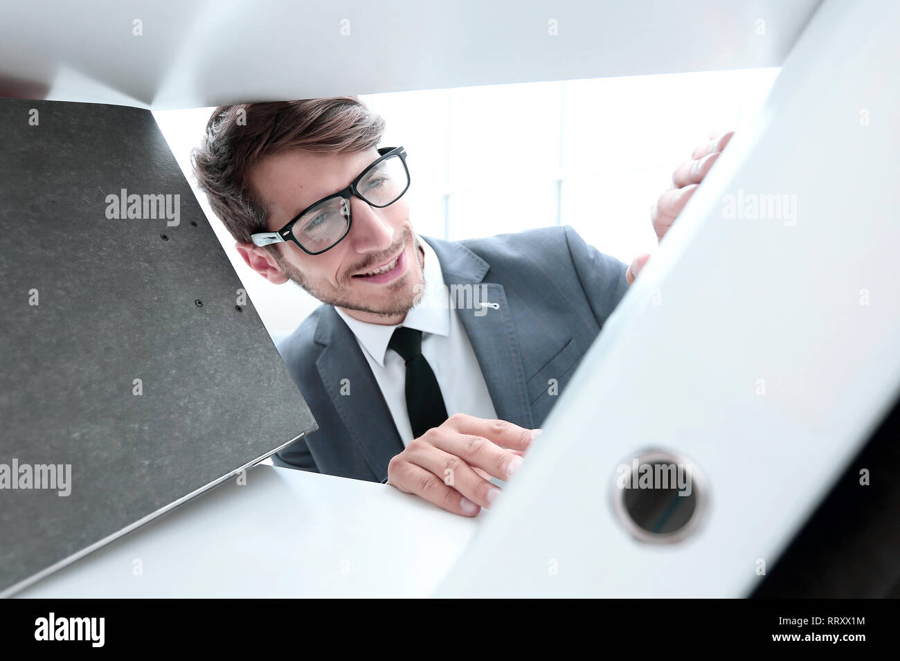 young businessman selects a folder for documents Stock Photo - Alamy