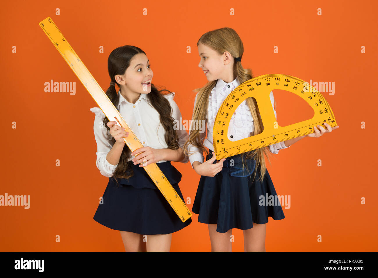 For good measure. School children with measuring instruments. Little ...