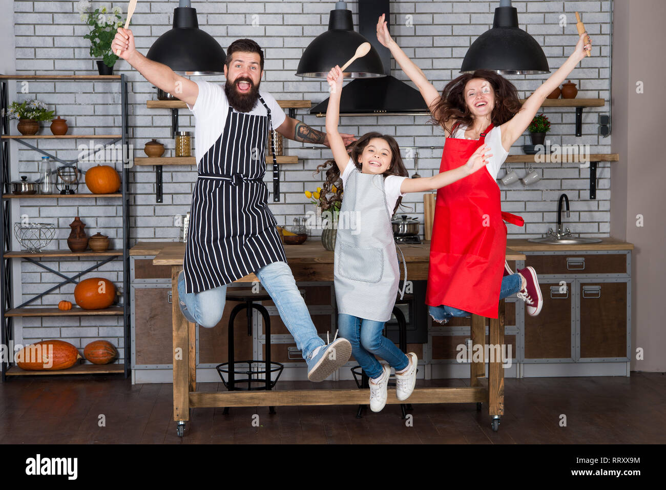 Happy cooking. Mother and father with little girl. Little girl with ...
