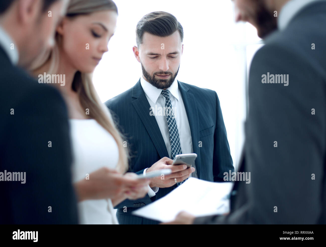 employees with smartphones check financial information Stock Photo - Alamy
