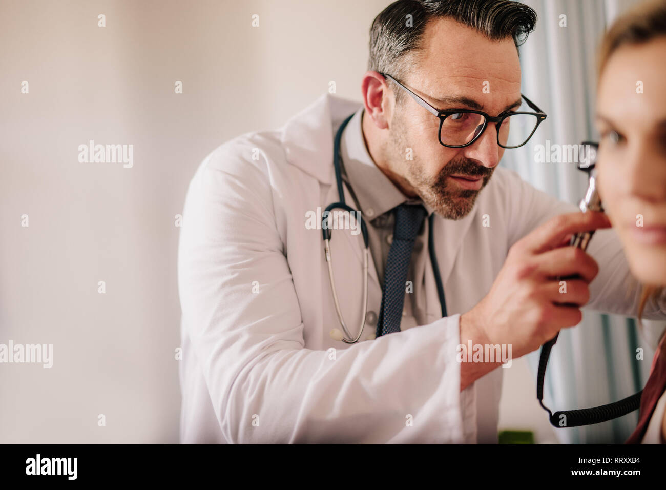 Doctor ear examination hi-res stock photography and images - Alamy