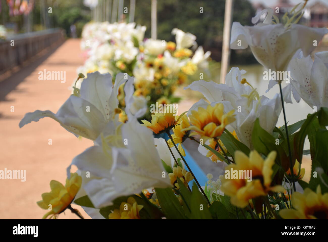 Colorful flower bouquet on the bridge to Kyauk Ka Lat pagoda on the ...