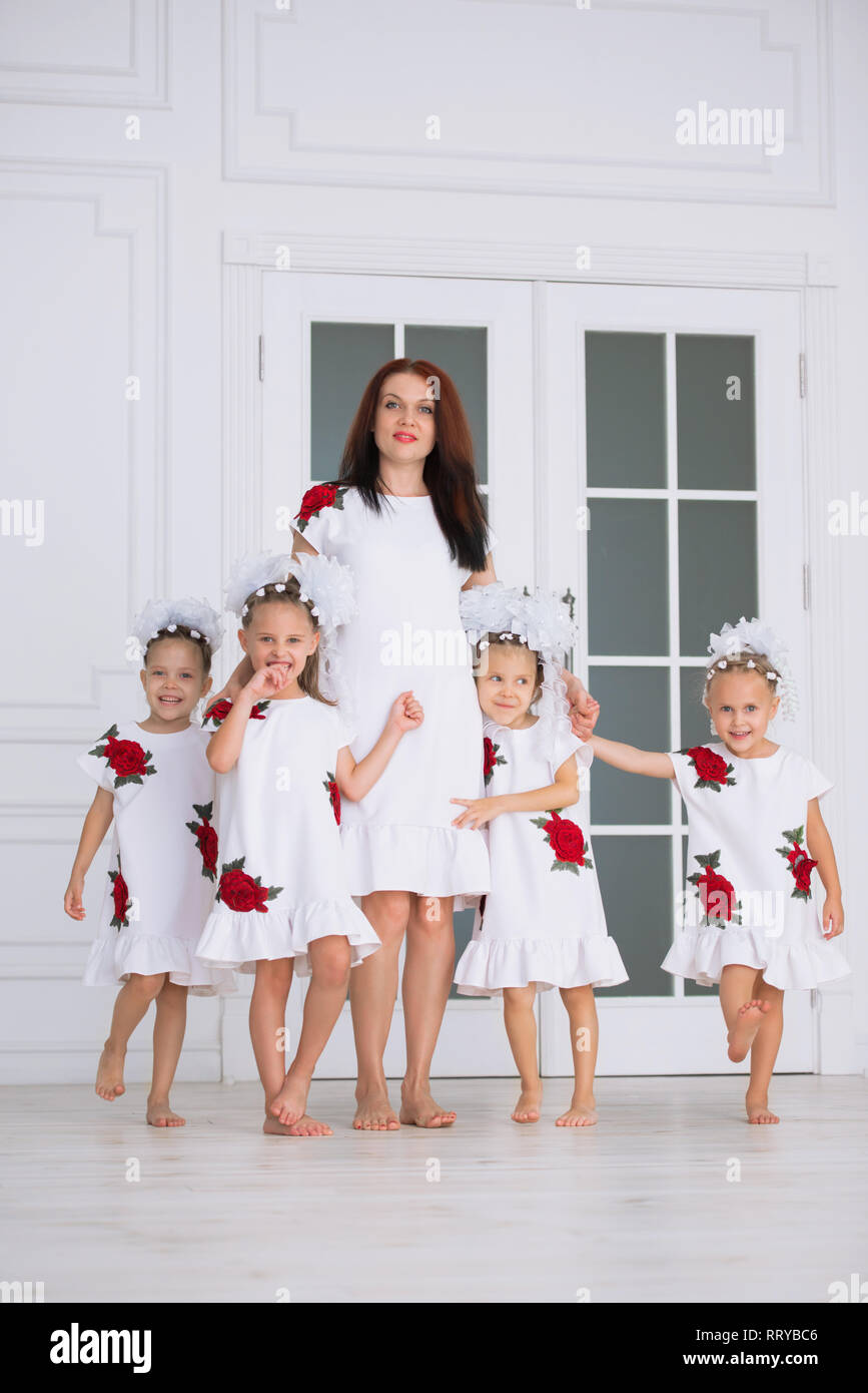 Happy large family of mother with four daughters in embroidered white ...