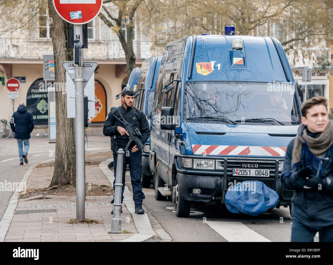 STRASBOURG, FRANCE - DEC 11, 2018: Police officer with rifle near blue ...