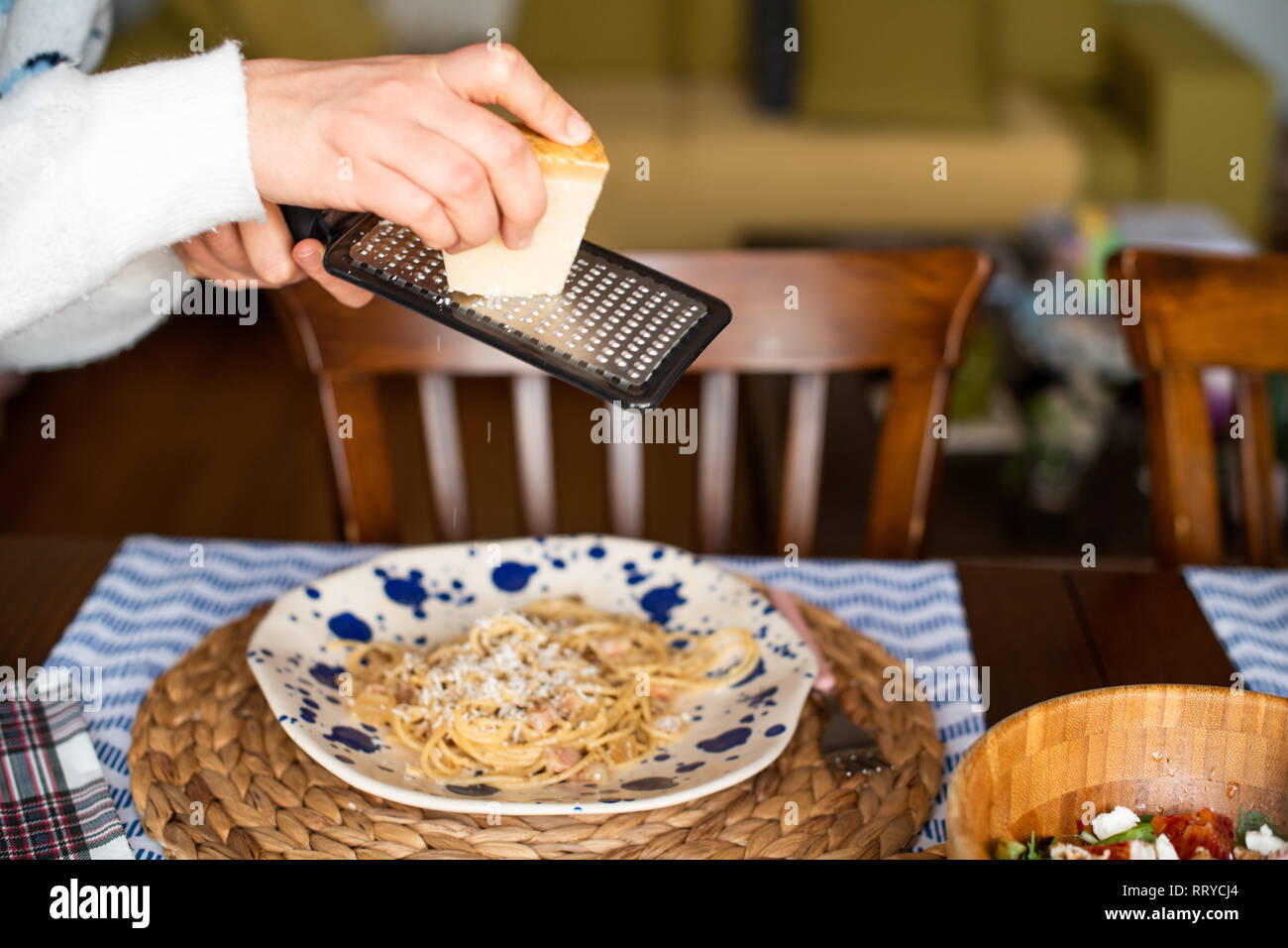 woman hands grating parmesan cheese on pasta carbonara Stock Photo - Alamy
