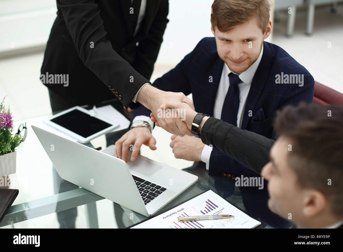 Handshake agreement over table hi-res stock photography and images - Alamy
