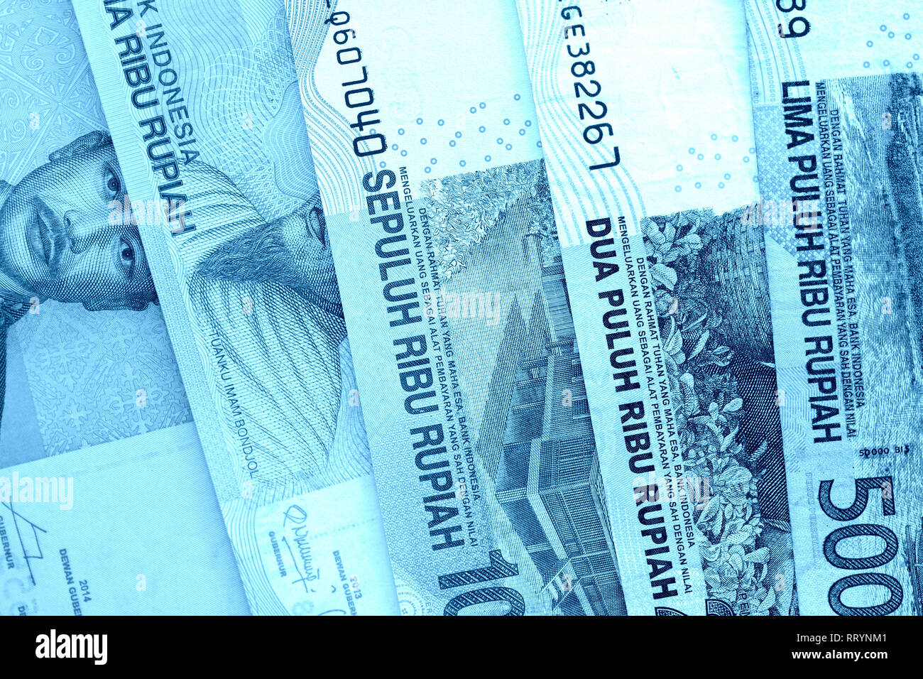 Several Indonesian rupiah banknotes close up. Blue color toned Stock ...