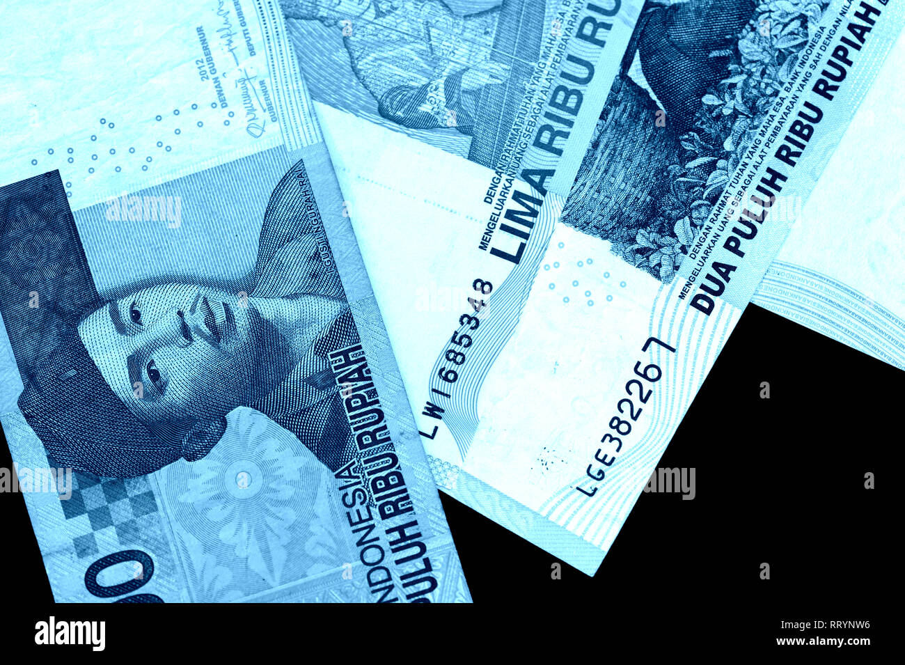 Several Indonesian rupiah banknotes close up. Blue color toned Stock ...