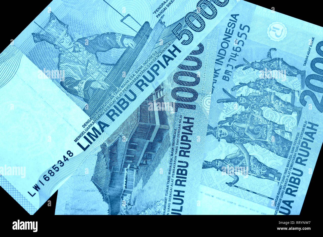 Several Indonesian rupiah banknotes close up. Blue color toned Stock ...
