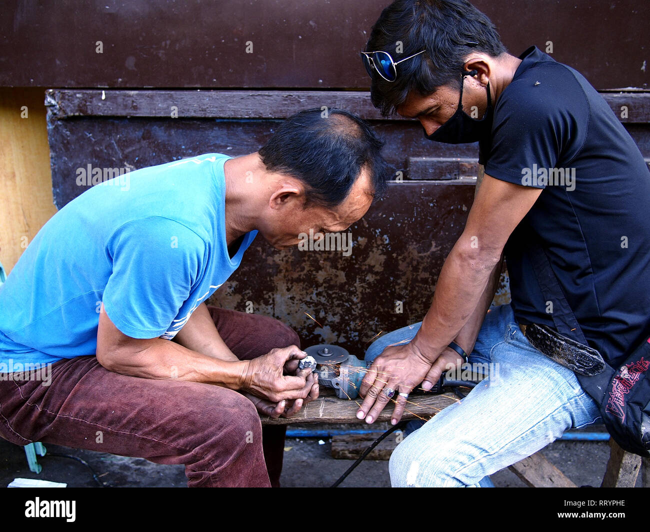ANTIPOLO CITY, PHILIPPINES - FEBRUARY 21, 2019: Two mechanics fix a ...