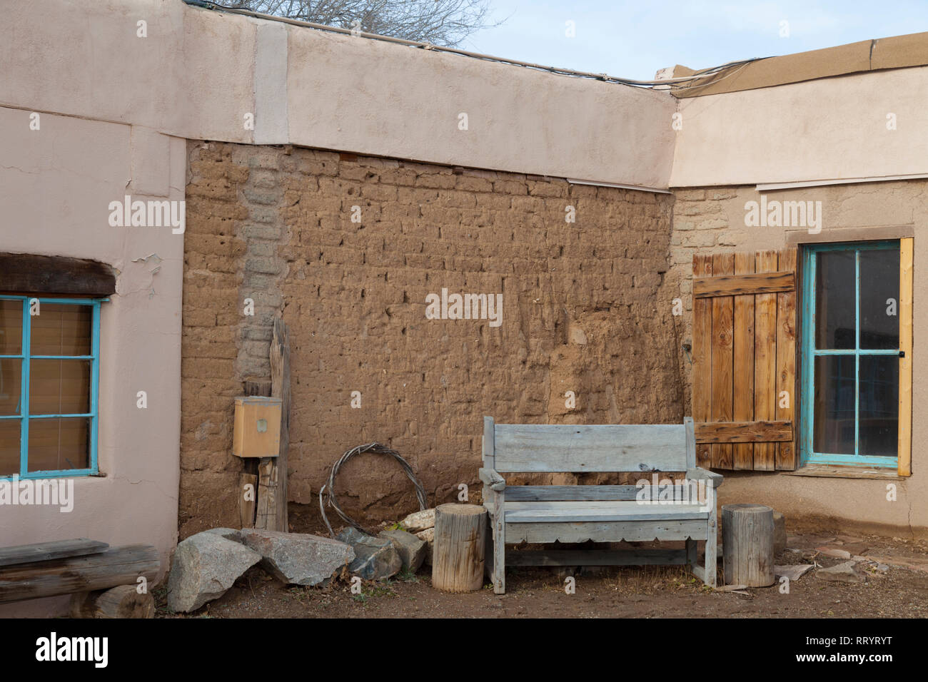 Turquoise bench by adobe wall Stock Photo - Alamy