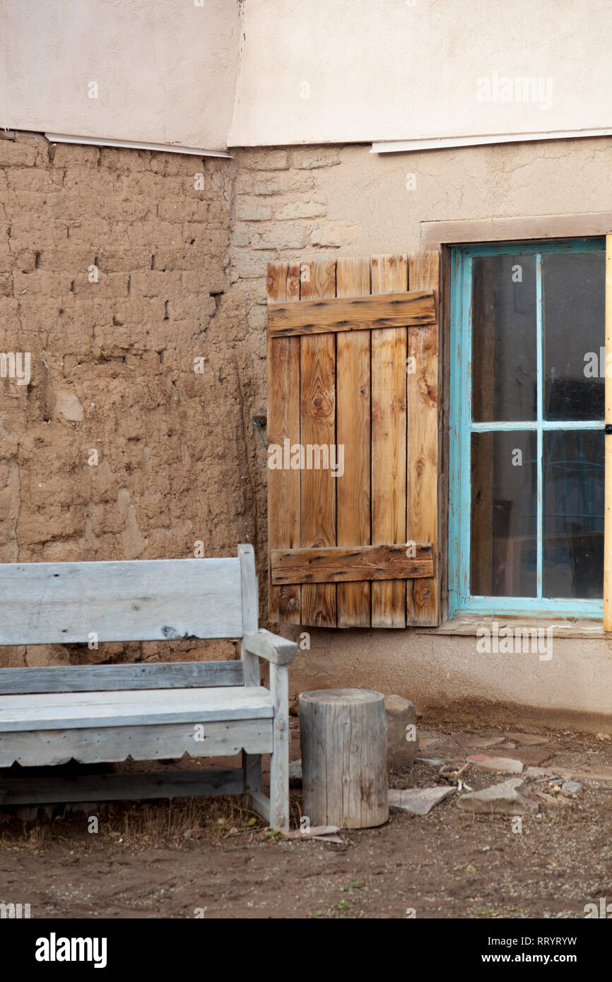 Turquoise bench by adobe wall Stock Photo - Alamy