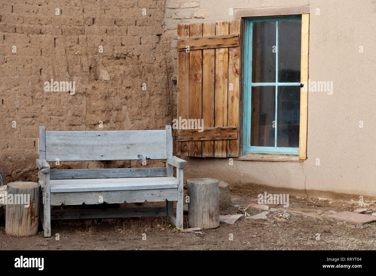 Turquoise bench by adobe wall Stock Photo - Alamy