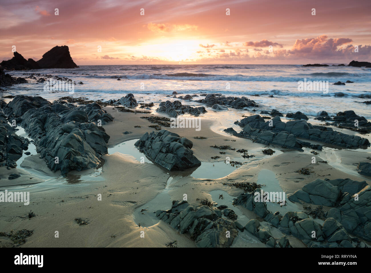 Sunset on the rocky beach at Hartland Quay on the north coast of Devon ...