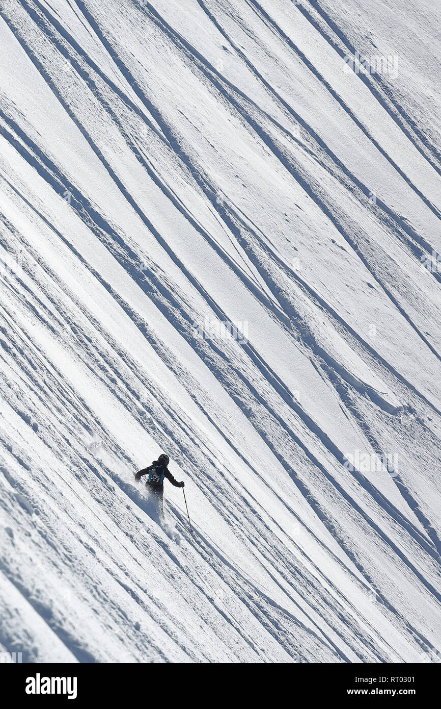Person riding a very steep ski shredded slope with many lines Stock ...