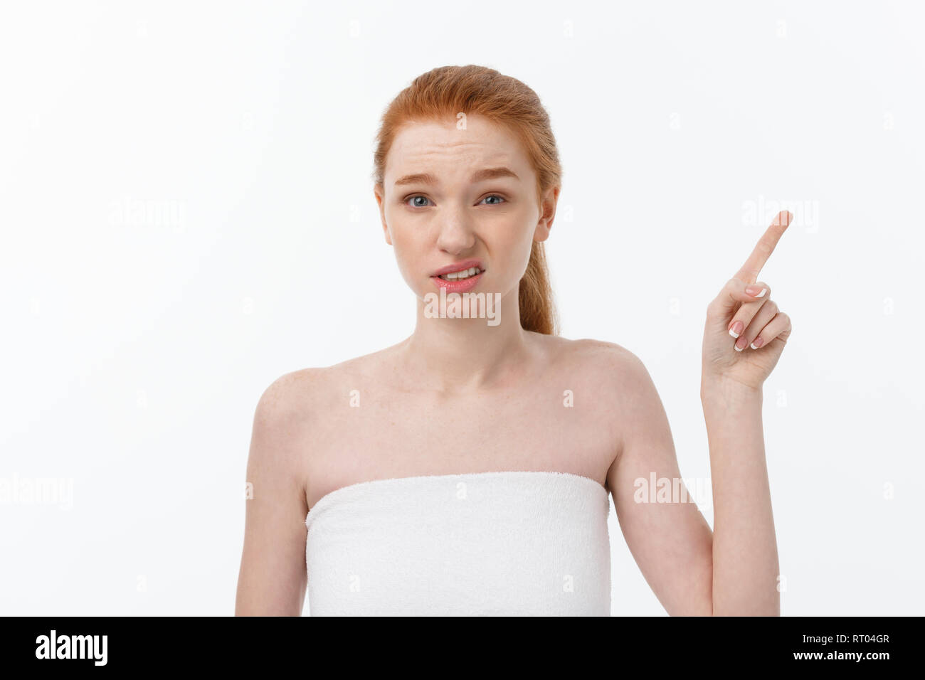 Portrait of caucasian cute in concern and shock, pointing index finger ...