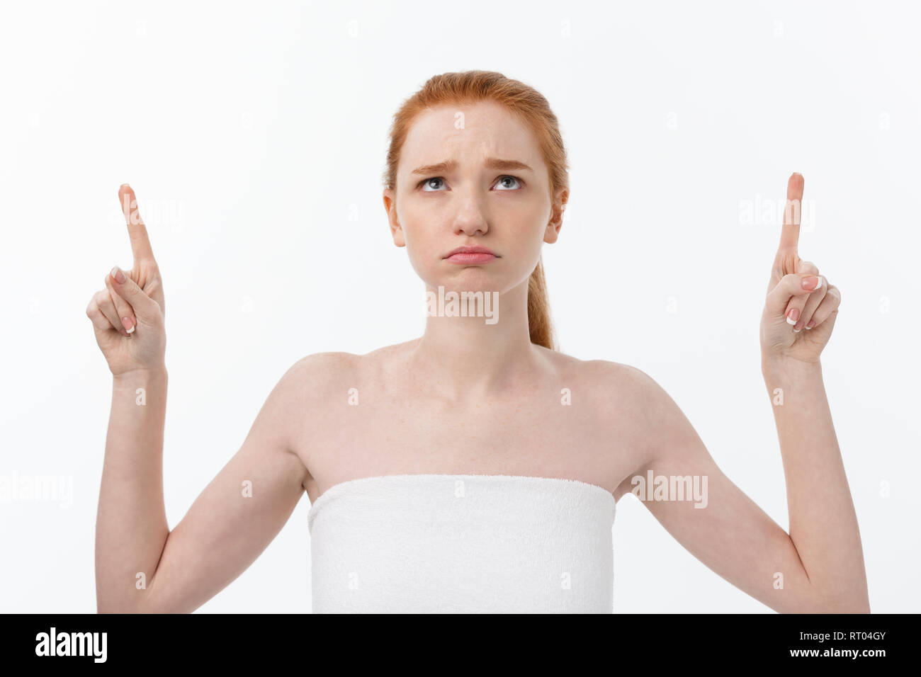 Portrait of caucasian cute in concern and shock, pointing index finger ...