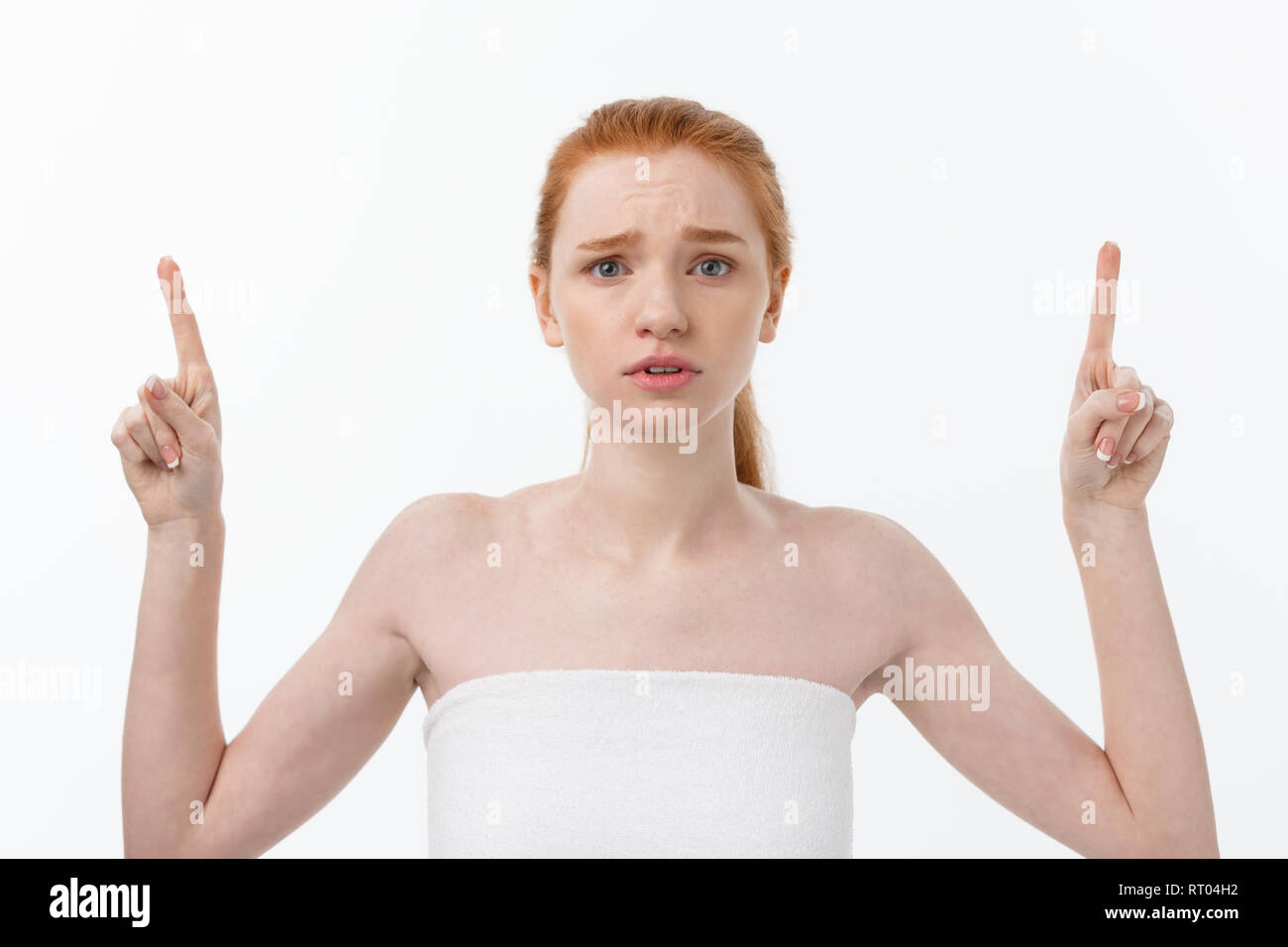 Portrait of caucasian cute in concern and shock, pointing index finger ...