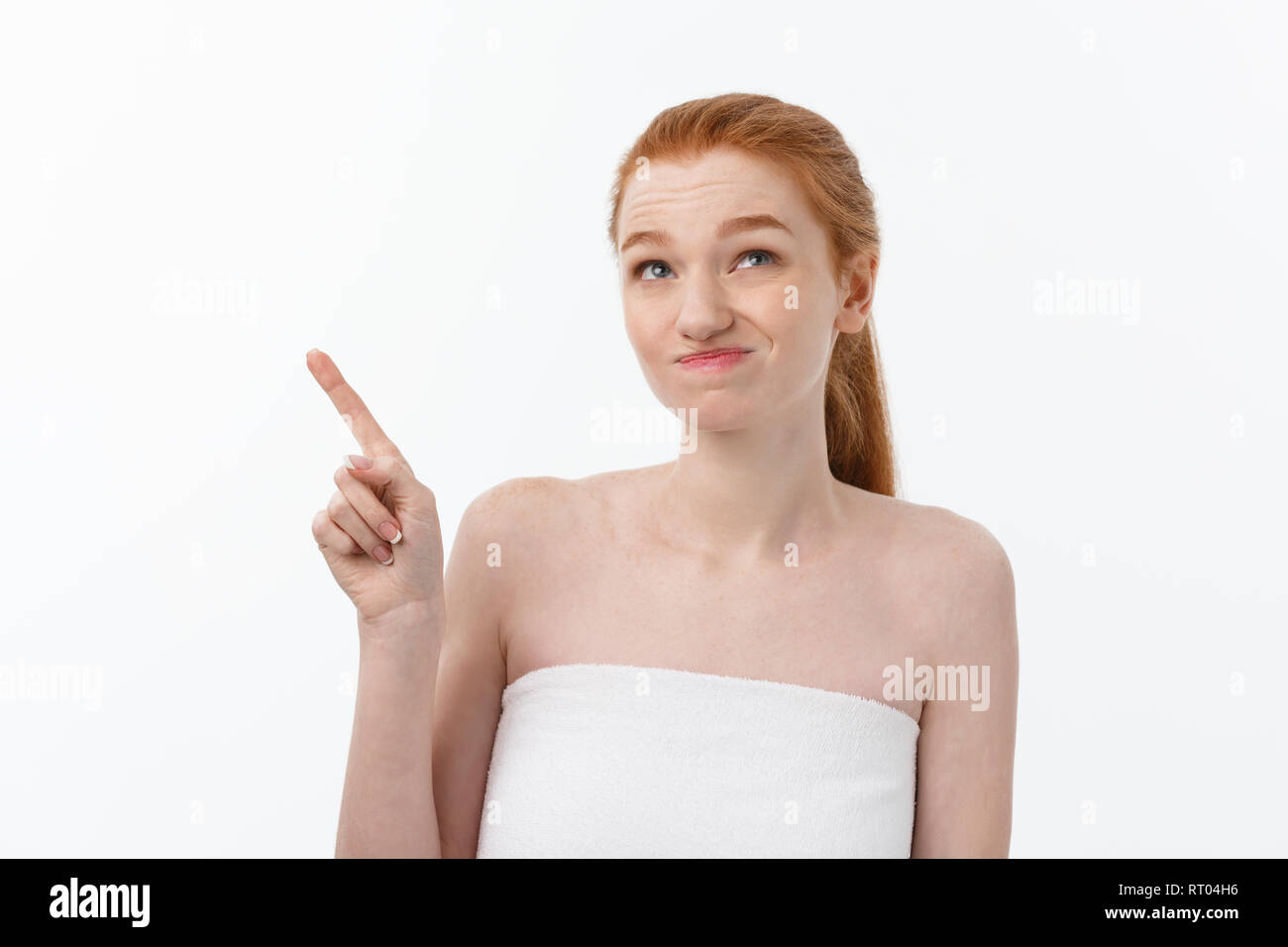 Portrait of caucasian cute in concern and shock, pointing index finger ...